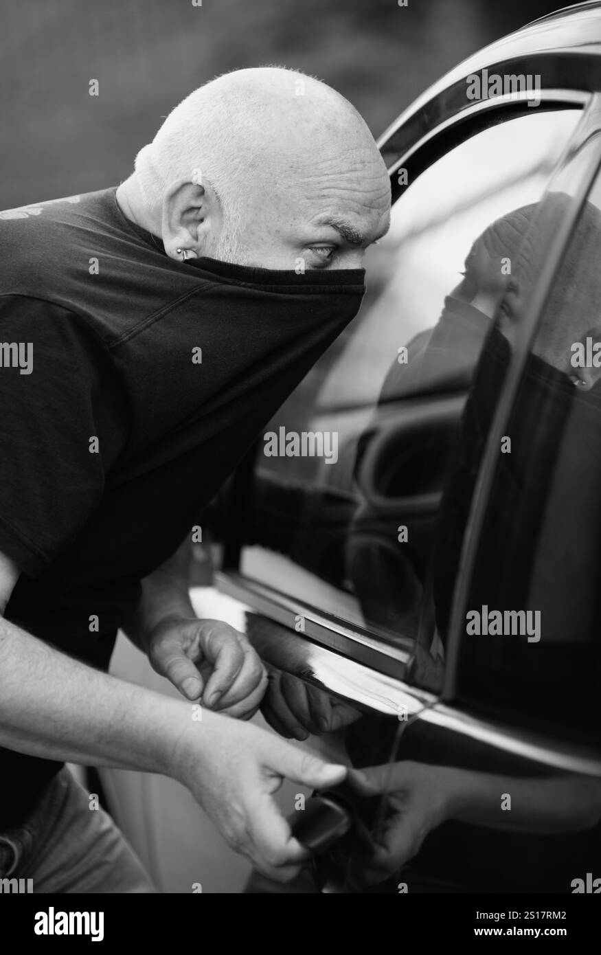 Thief stealing a car, robber. Car thief steal car breaking door Stock ...