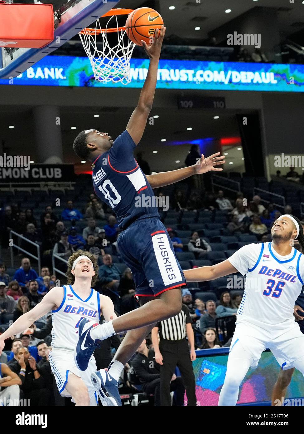 UConn guard Hassan Diarra, center, drives to the basket as DePaul guard ...