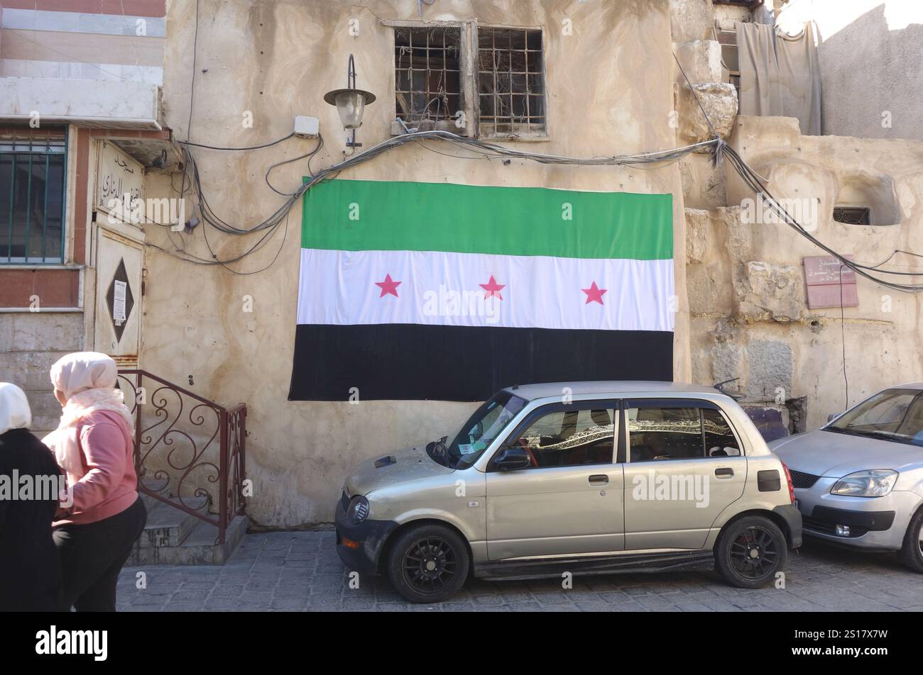 A new Syrian flag seen on a wall of old Damascus, Syria, January 1 2025 ...