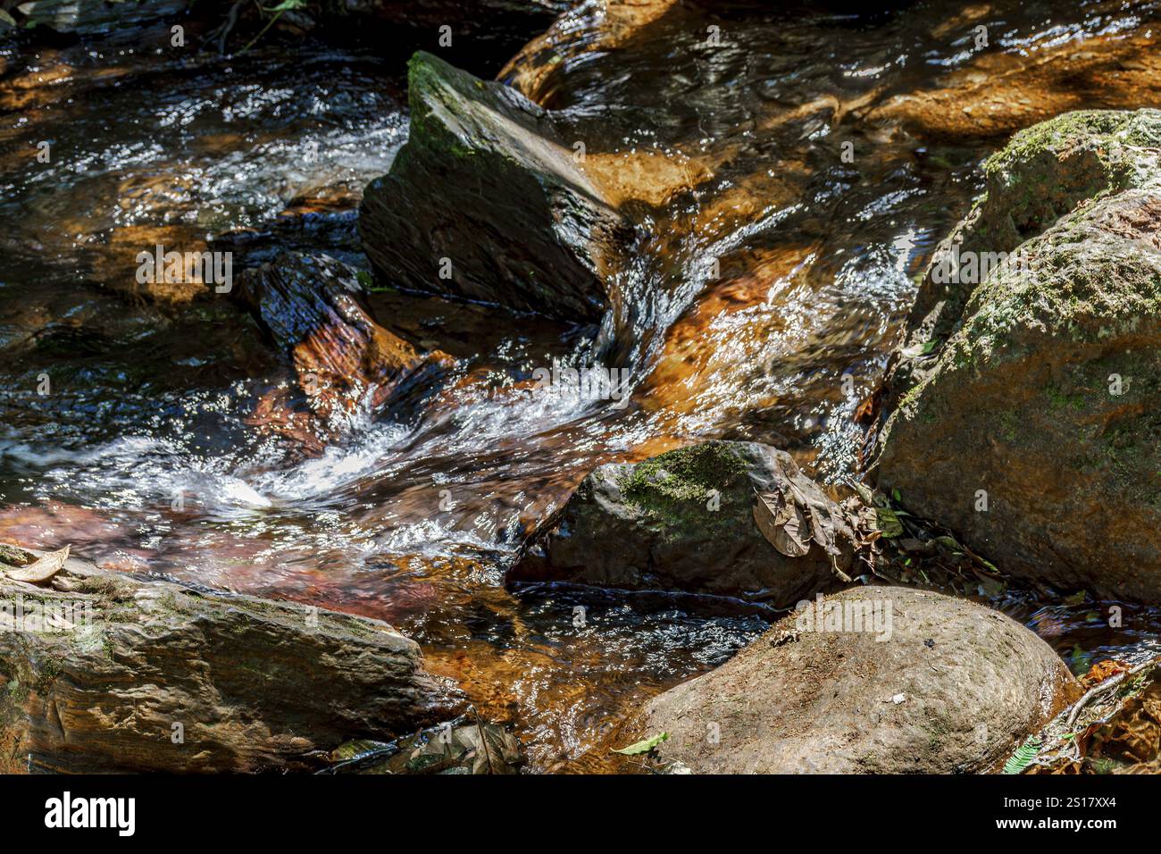 Water from a small river flowing between rocks in Minas Gerais Minas ...