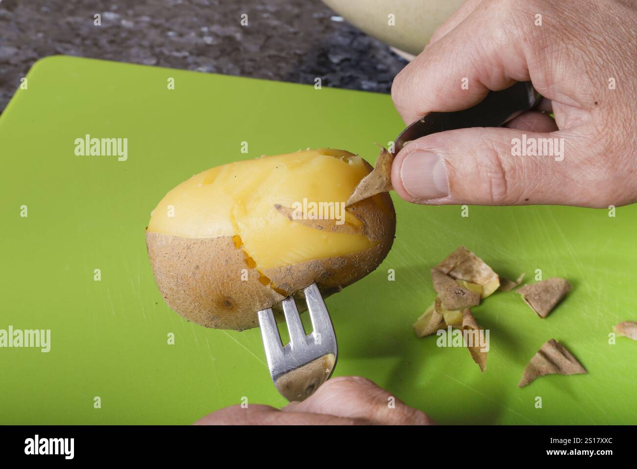 Man peeling boiled potato knife hi-res stock photography and images - Alamy