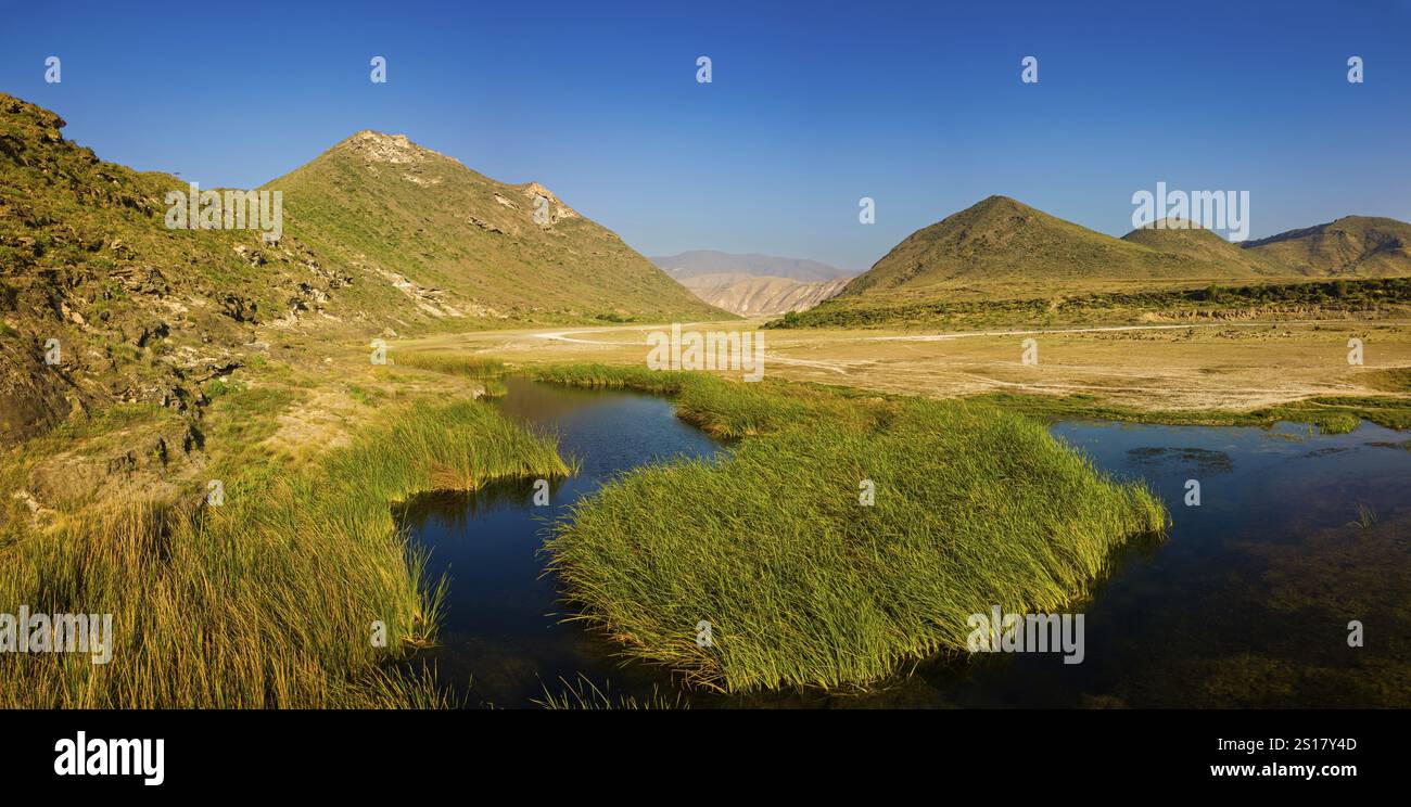 Landscape in Oman, mountains, Wadi Ashawq, road, reeds, waters Salalah ...