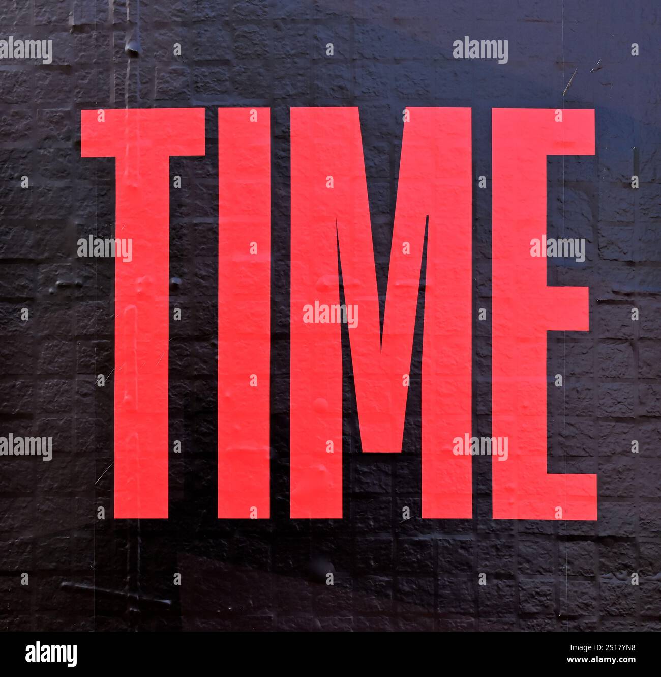 Word TIME in red on a black wall Stock Photo - Alamy