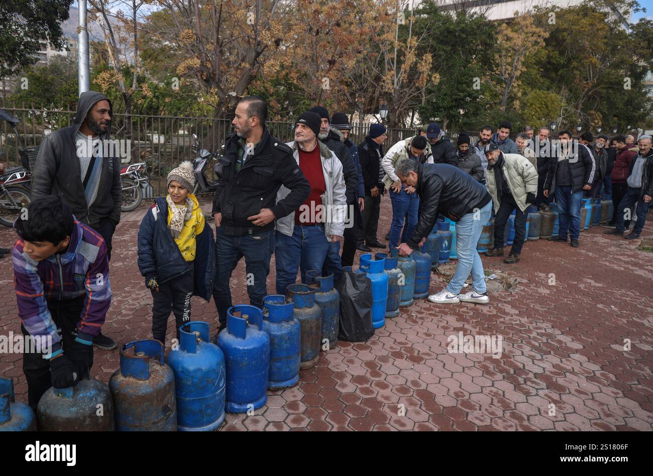 People queue to buy gas cylinders in central Damascus, Syria, Tuesday ...