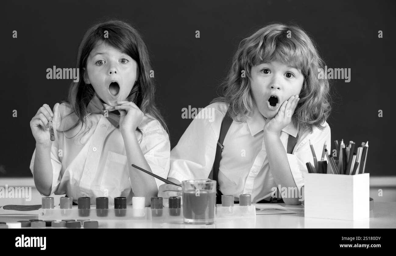 Excited school surprised children drawing a colorful pictures with ...
