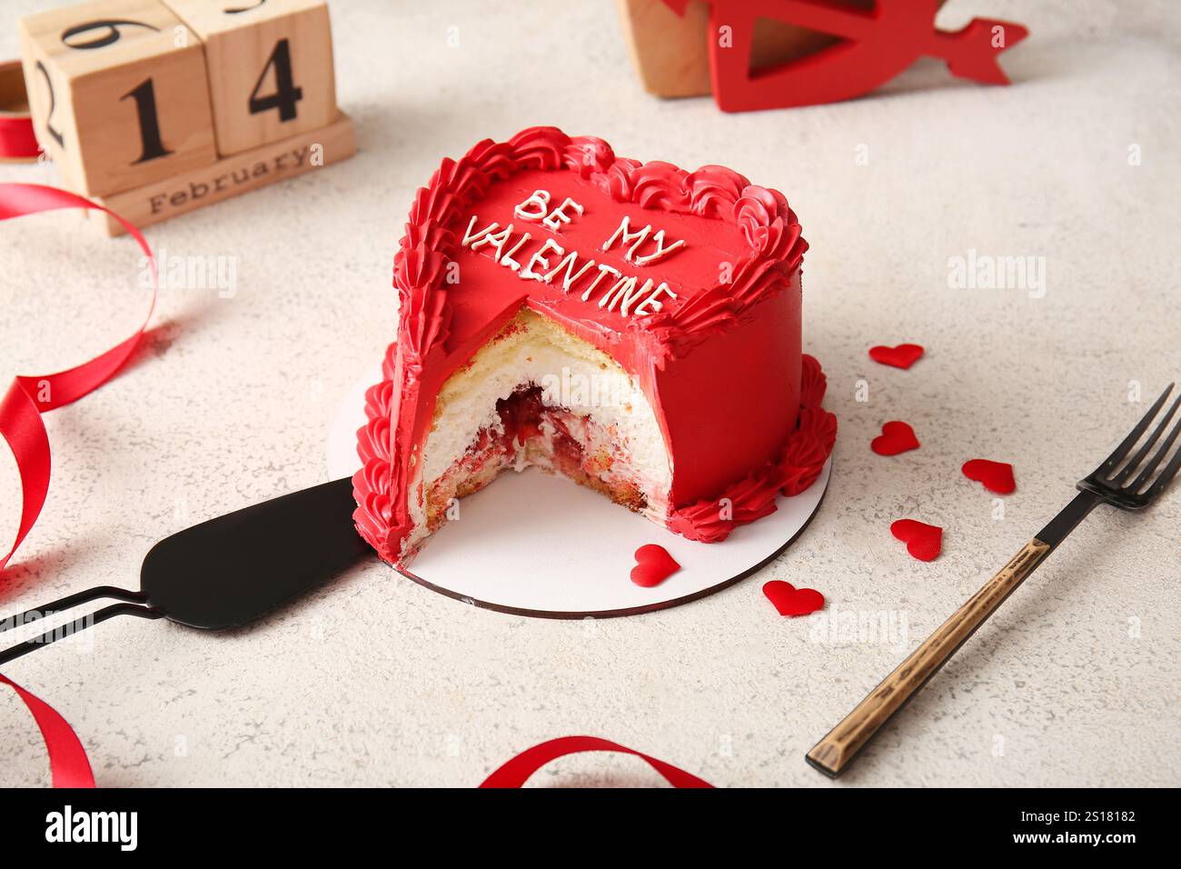 Cut sweet bento cake and cube calendar on white background. Valentine's ...
