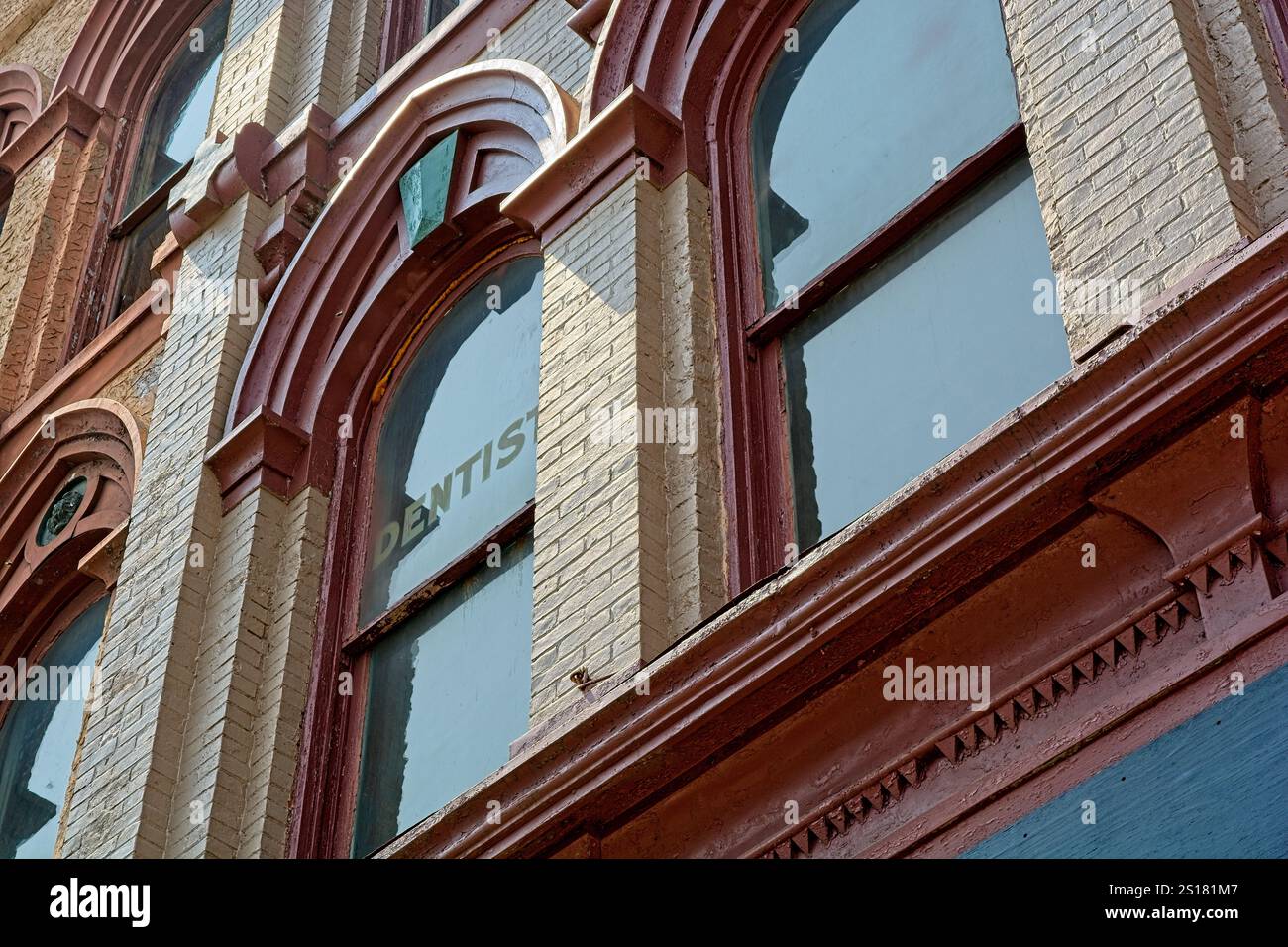Ornate detail window pediments and brick work on facade of 1888 brick ...