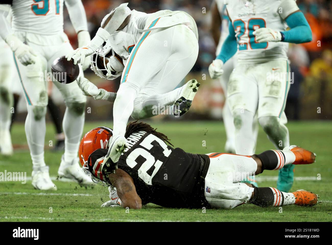 Miami Dolphins safety Jevon Holland (8) is knocked down by Cleveland ...