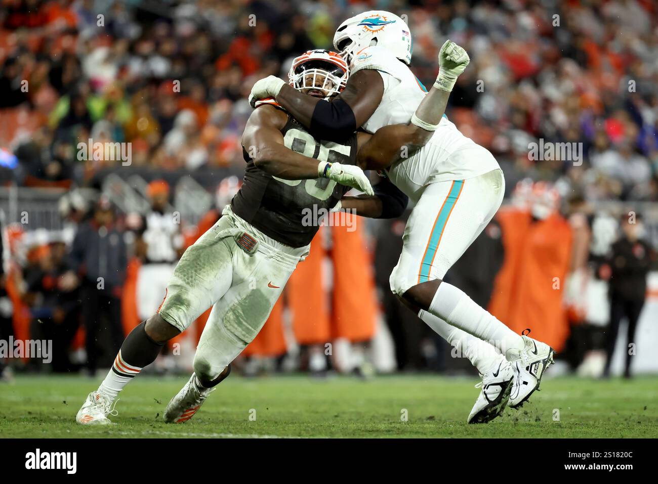 Cleveland Browns defensive end Myles Garrett (95) is held by Miami ...