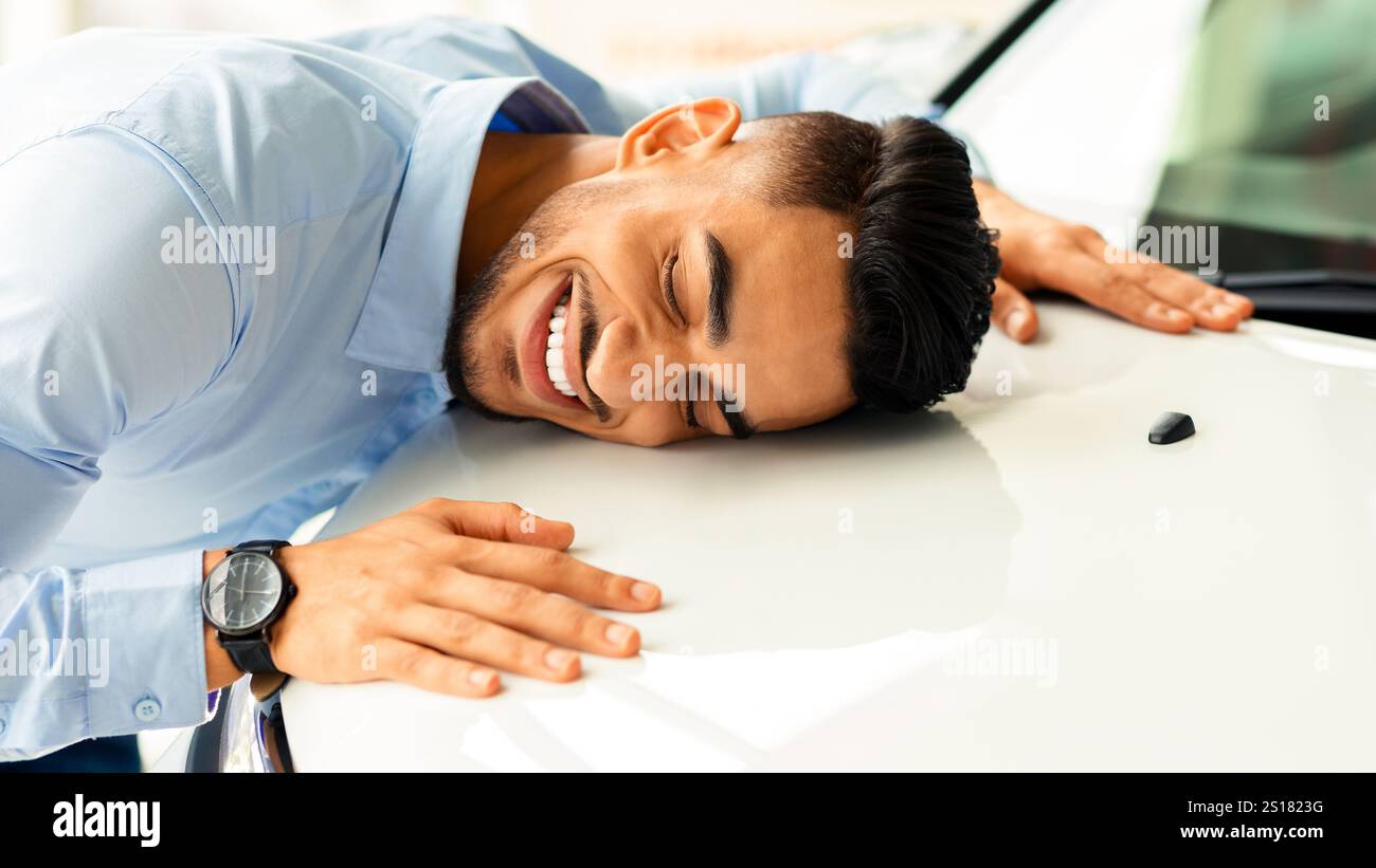 Happy young arab man hugging car of his dream Stock Photo - Alamy