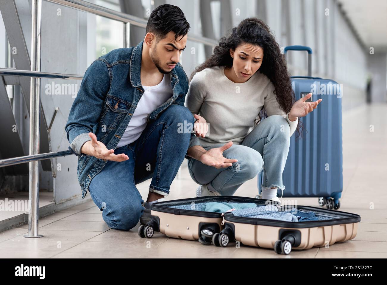 Stressed Young Arab Couple Having Problems With Luggage At Airport ...
