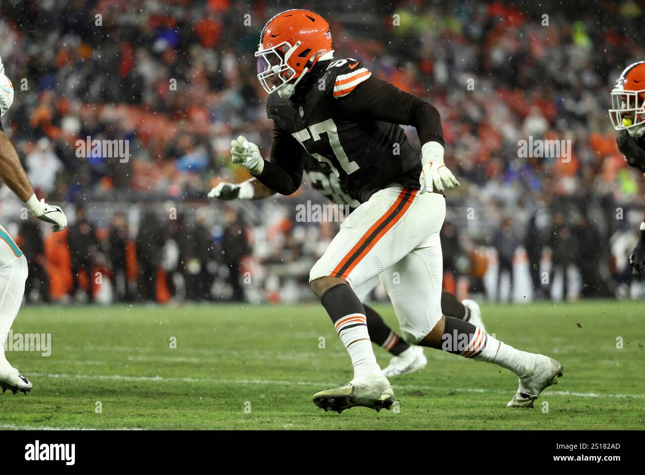 Cleveland Browns defensive end Isaiah McGuire (57) runs off of the line ...