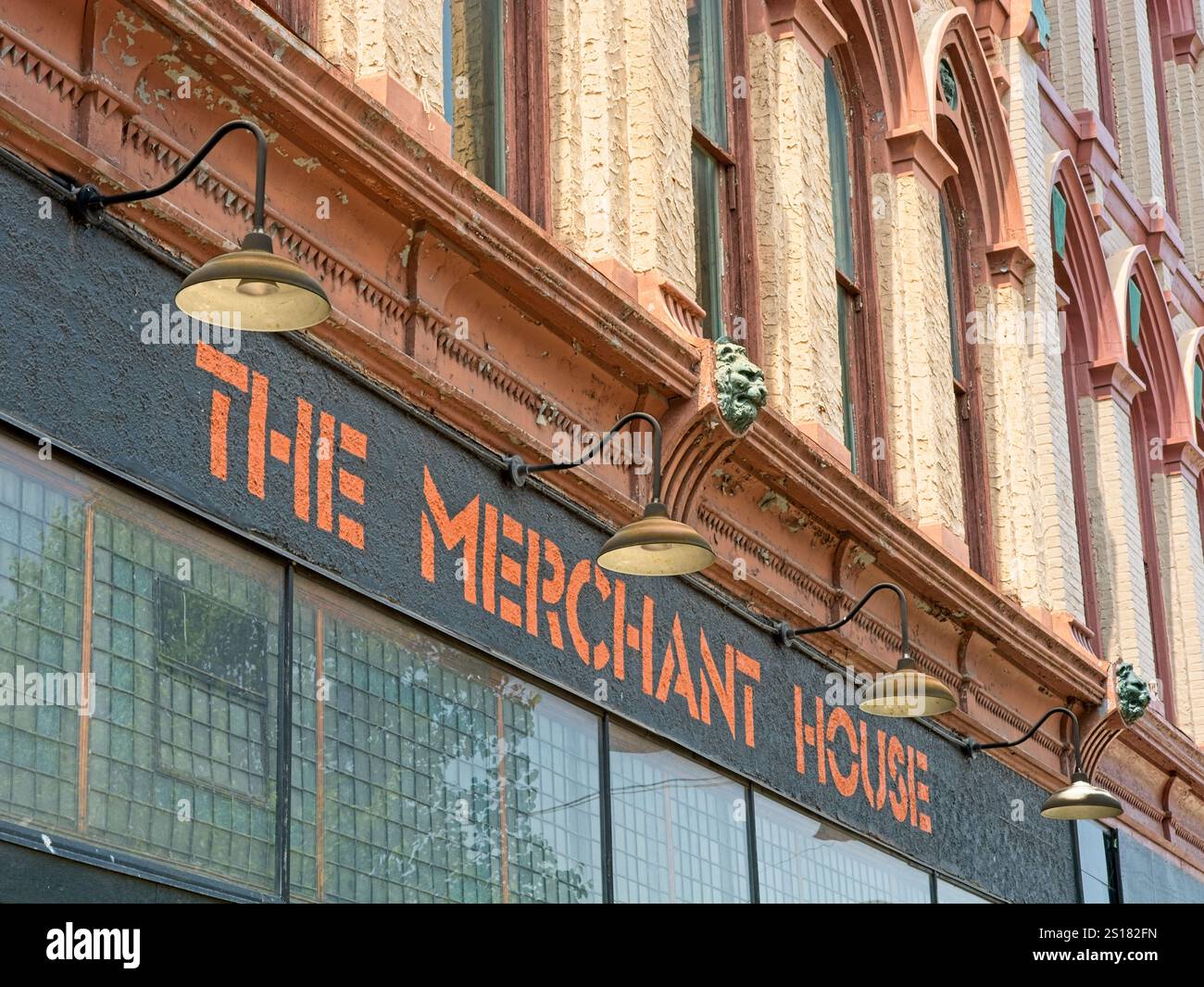 Fascia sign under gooseneck lamps of The Merchant House, a family run ...