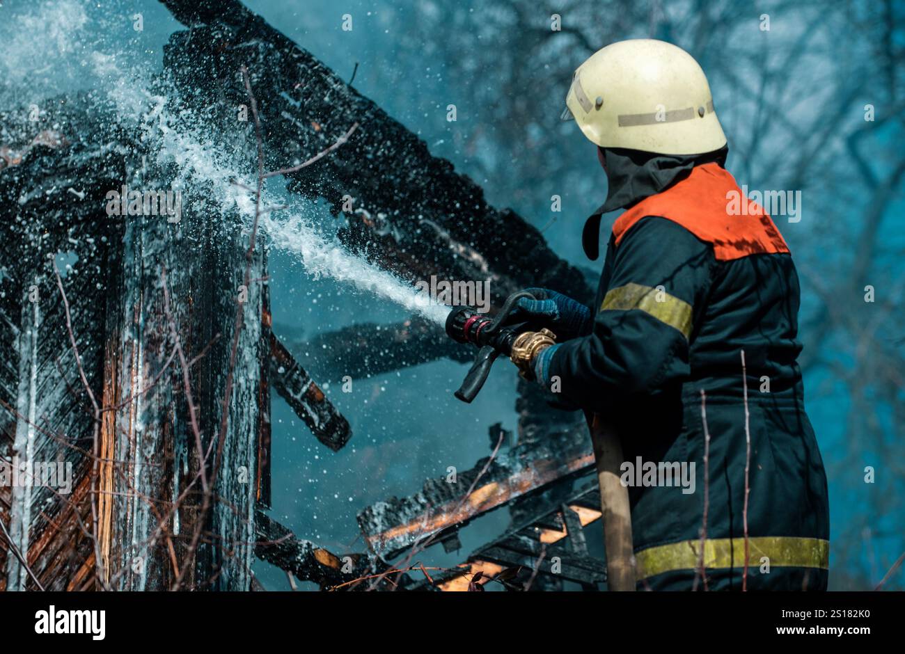 Fireman - men job. Firefighter are using water in fire fighting ...
