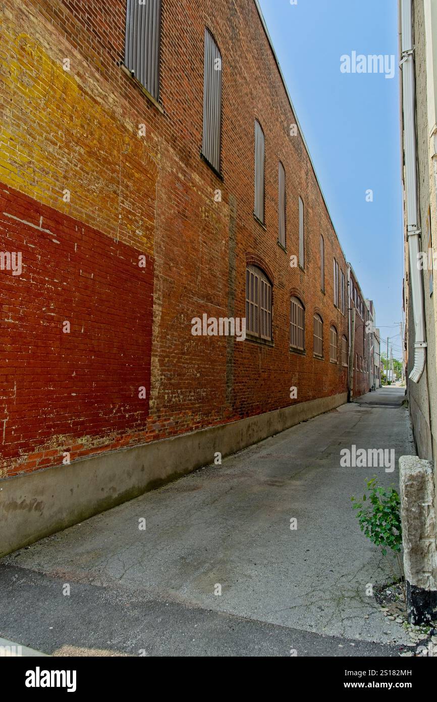 Alley way between brick walls with painted over ghost signs Stock Photo ...