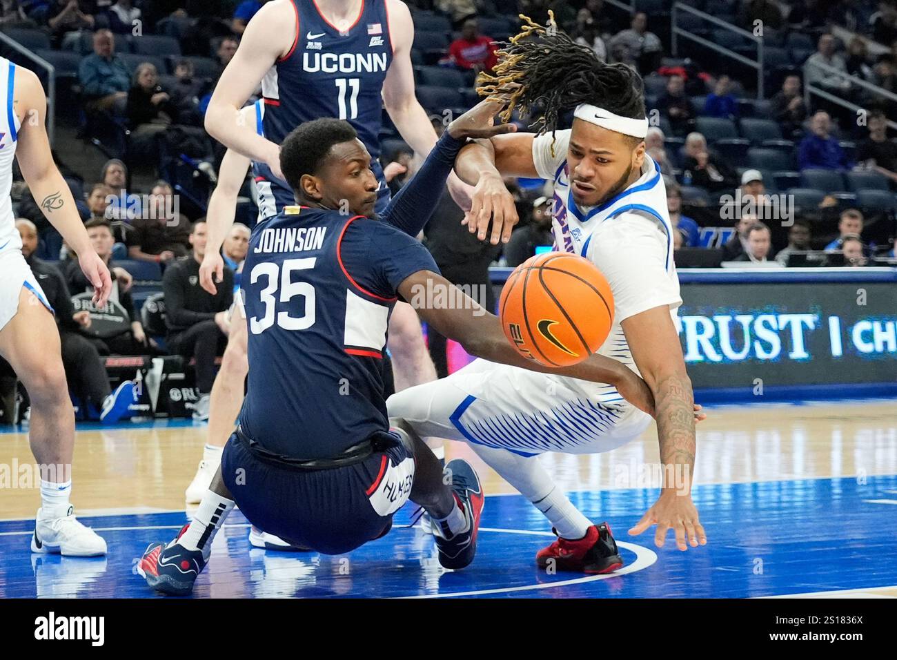 UConn center Samson Johnson, left, and DePaul forward NJ Benson battle ...