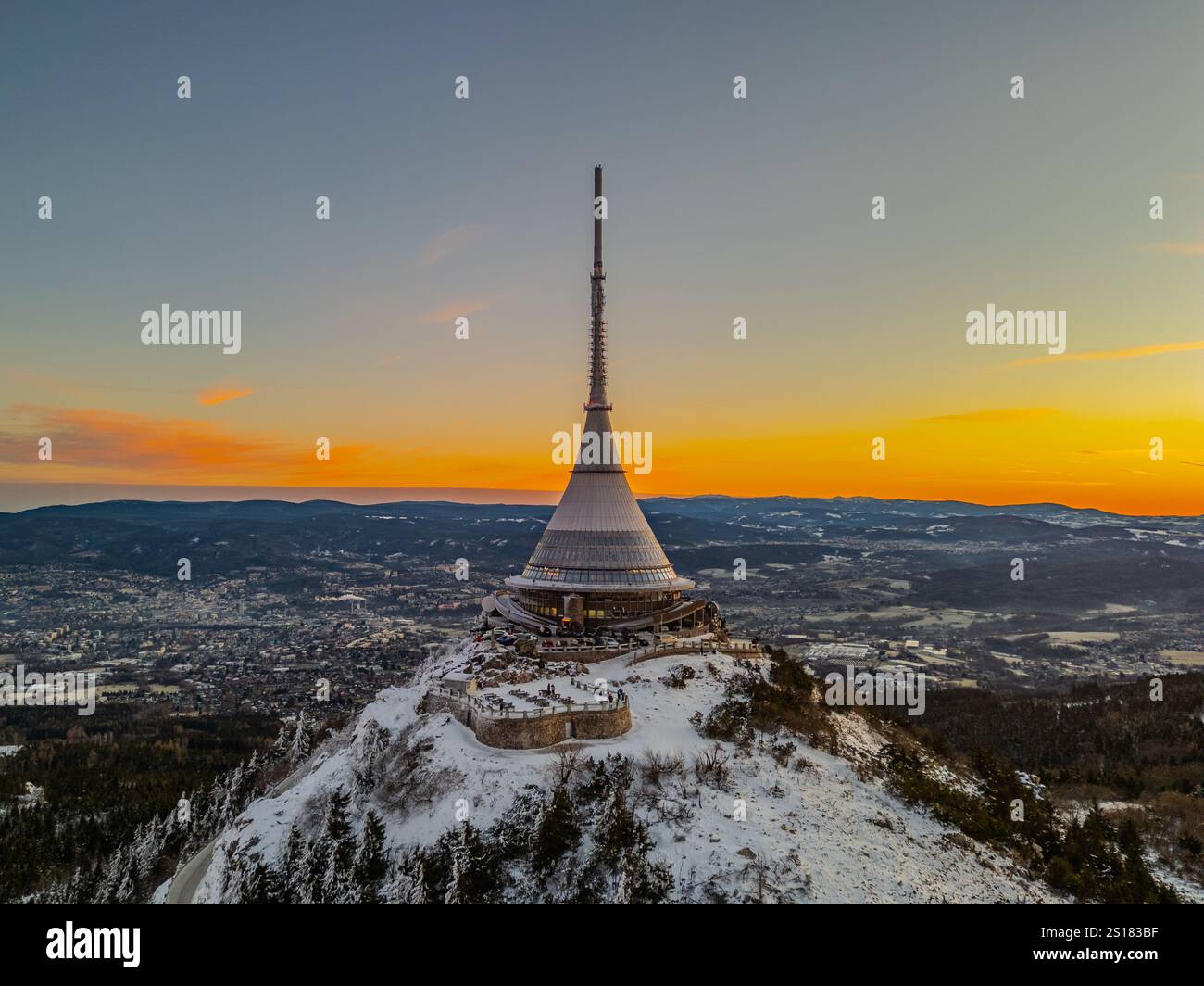 Dawn breaks over Jested Mountain, illuminating the snowy landscape. The ...