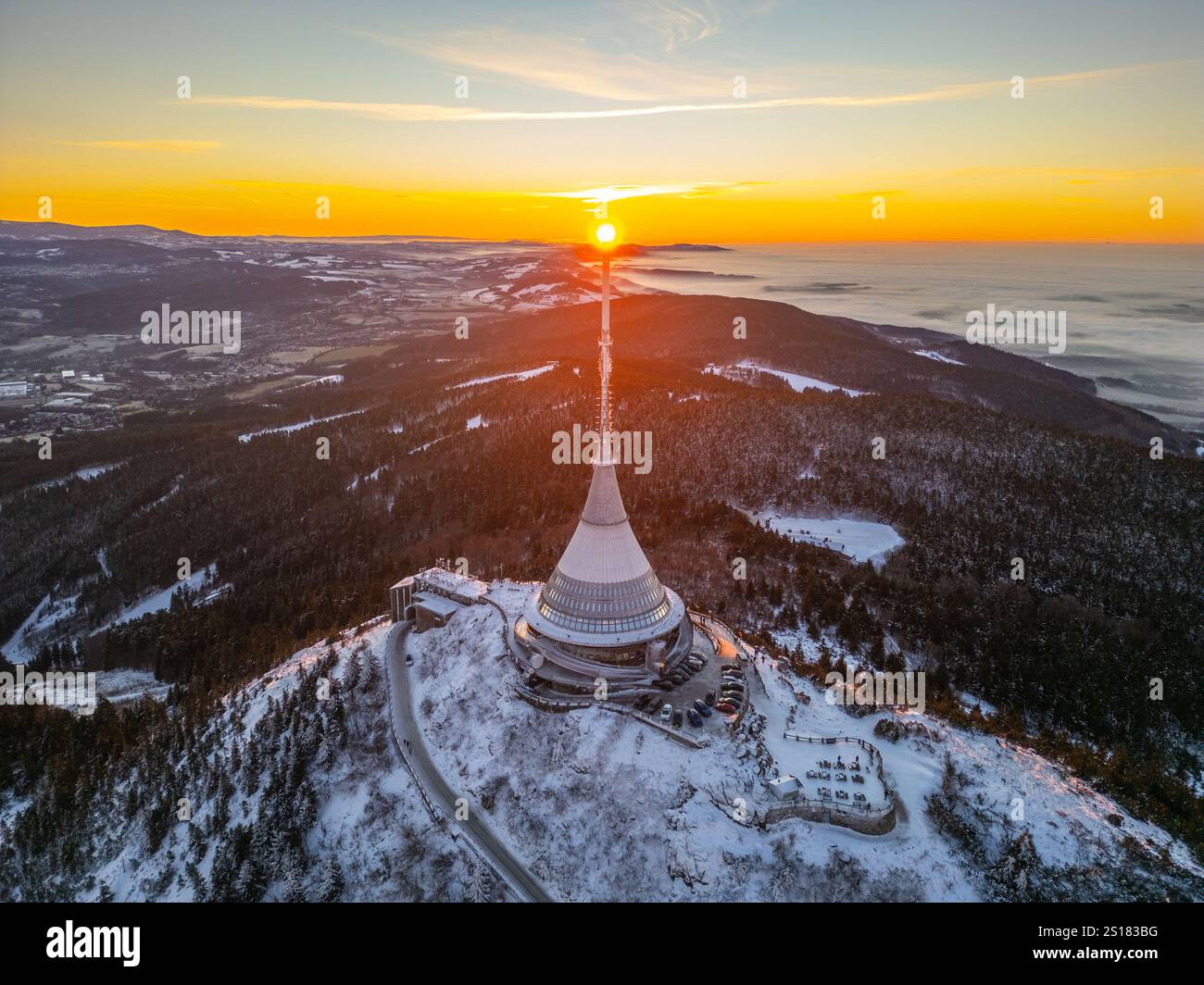 Jested Mountain reveals a breathtaking winter sunrise, casting golden ...