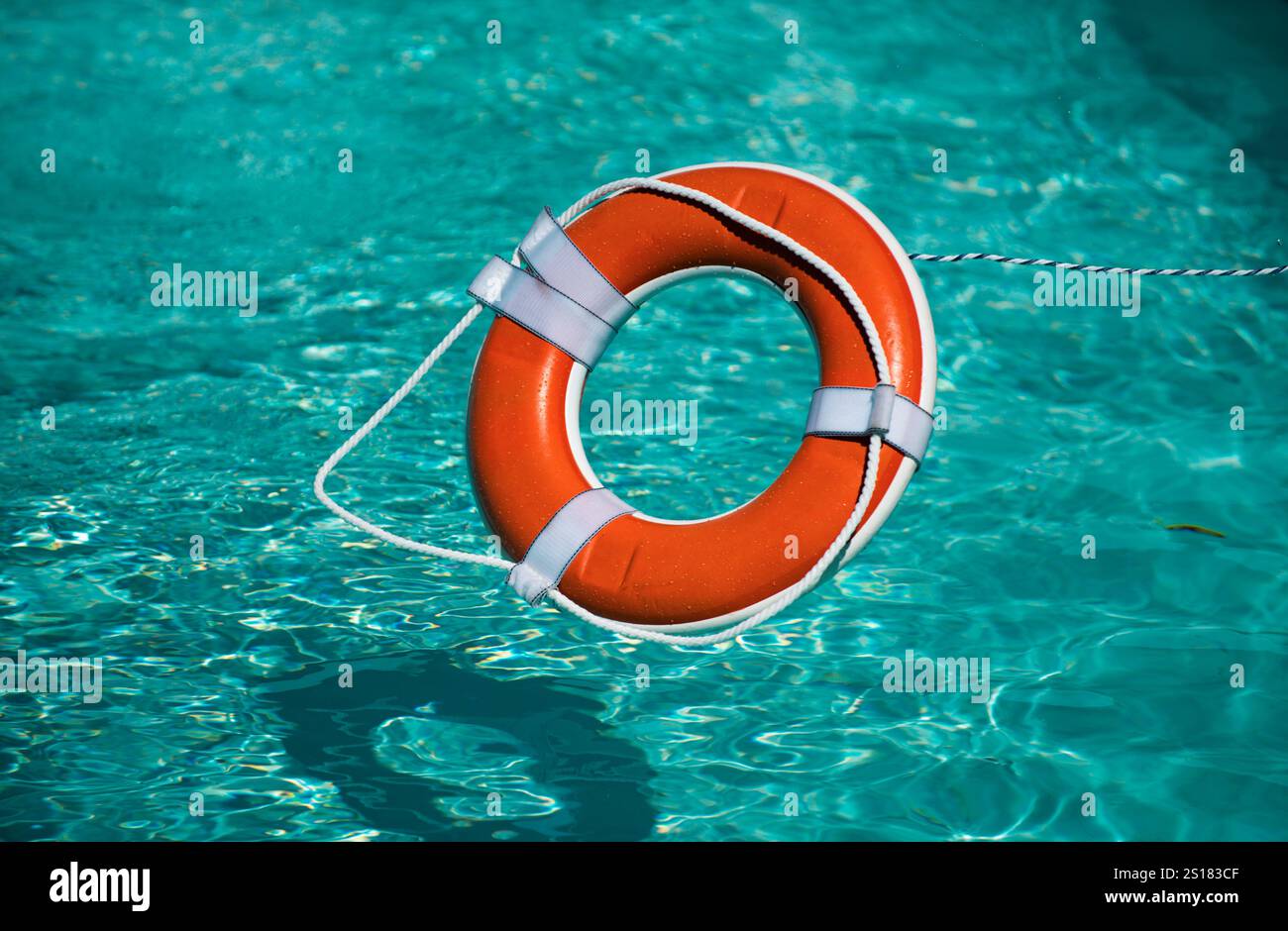 Lifebuoy pool ring float on blue water Stock Photo - Alamy