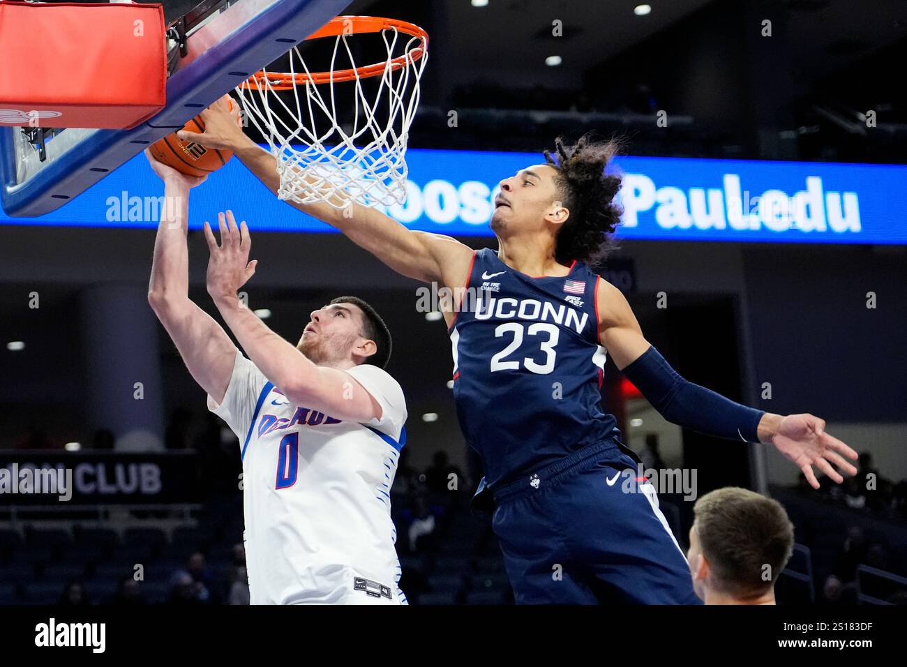 UConn forward Jayden Ross, right, blocks a shot by DePaul forward Troy ...