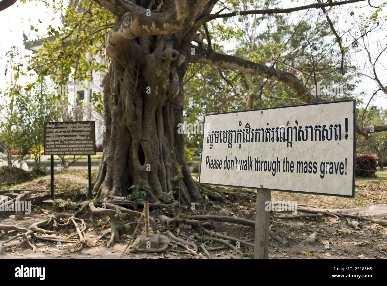 A sign warns visitors not to walk on the mass graves at the Choeung Ek ...