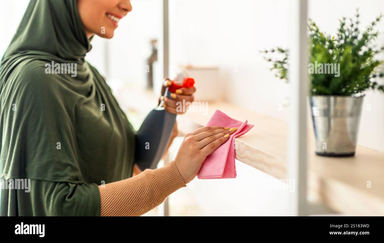 Muslim young woman cleaning shelfs at home at kitchen Stock Photo - Alamy