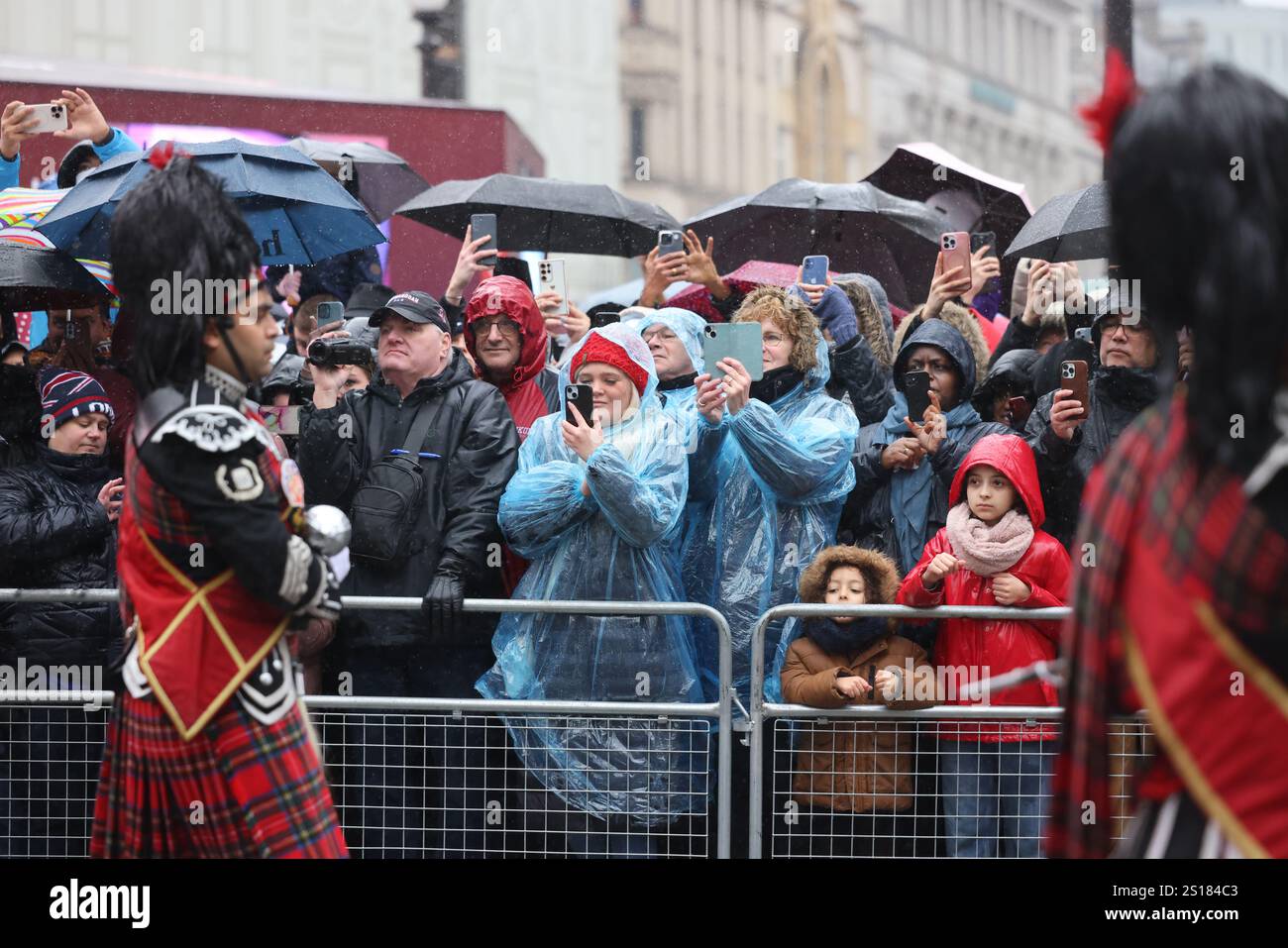 London, UK 1st January 2025.Revellers braved heavy rain to watch London ...