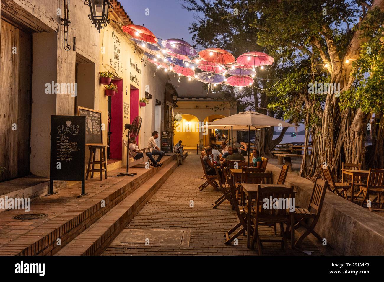 MOMPOX, COLOMBIA - MARCH 2, 2023: Night view of riverside restaurants ...