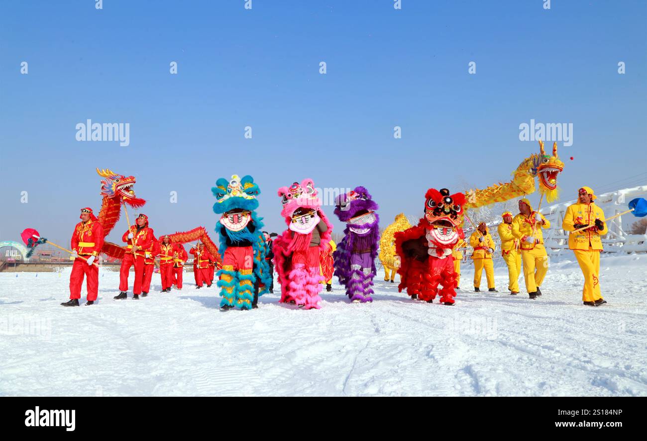 AKSU, CHINA - JANUARY 1, 2025 - Villagers perform a dragon and lion ...