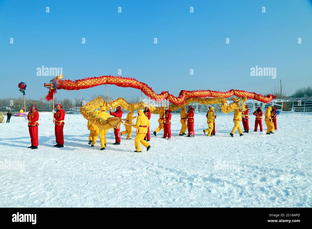 AKSU, CHINA - JANUARY 1, 2025 - Villagers perform a dragon and lion ...