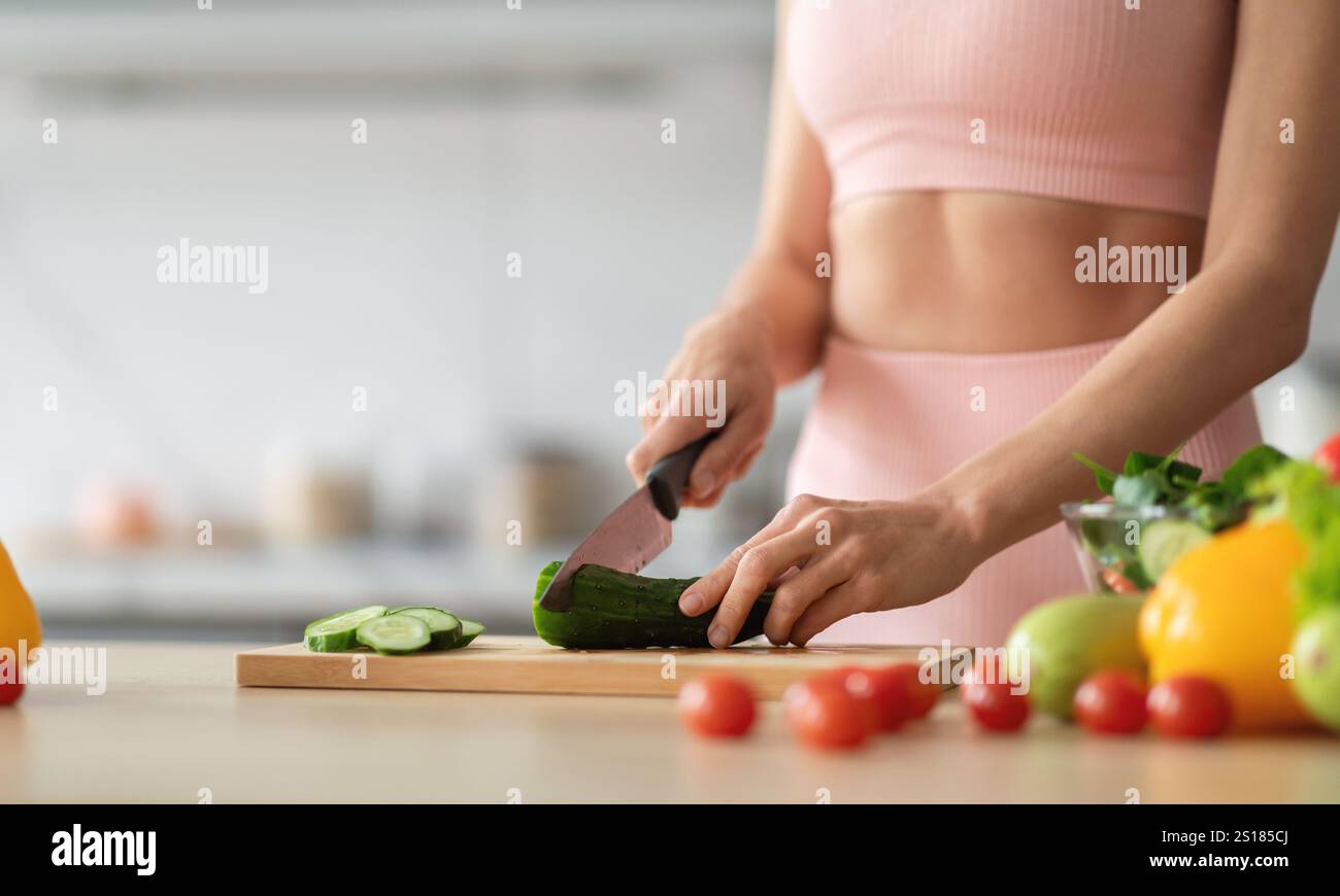 Woman preparing fresh vegetables in a modern kitchen for healthy meal ...