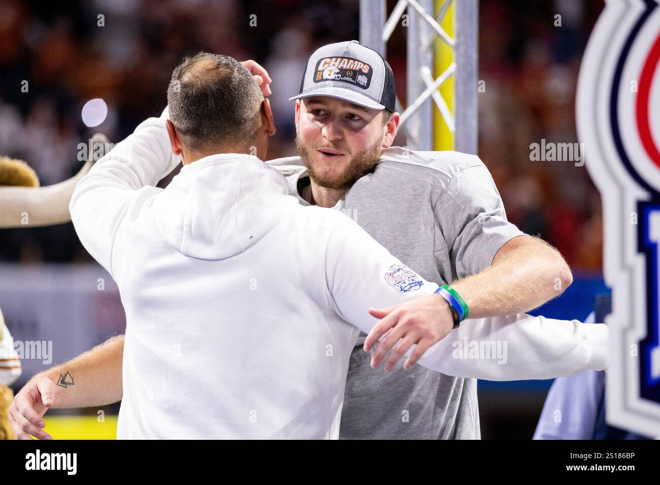 Atlanta, GA, USA. 1st Jan, 2025. Texas quarterback Quinn Ewers (3) hugs Texas head coach Steve ...