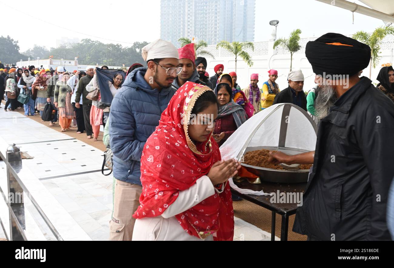 NEW DELHI, INDIA - JANUARY 1: Devotees visit Bangla Sahib gurudwara to offer prayers on the ...