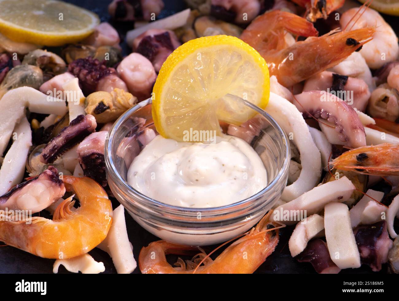Cocktail of seafood close-up. Mussels, octopus, squid and shrimp with ...