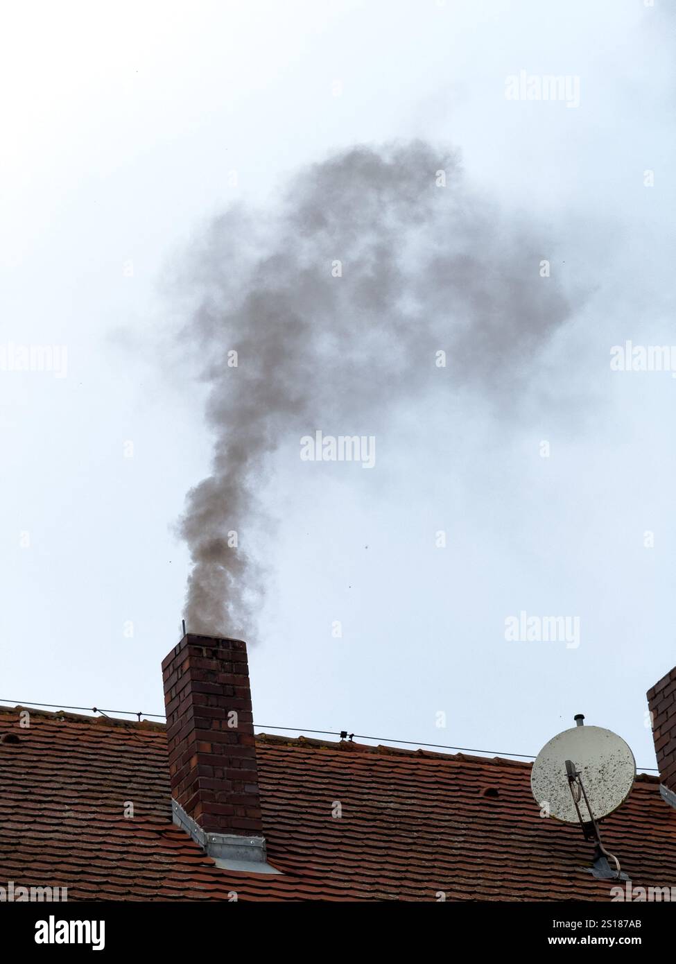 Smoking chimney. Smoke from wood stove Stock Photo - Alamy