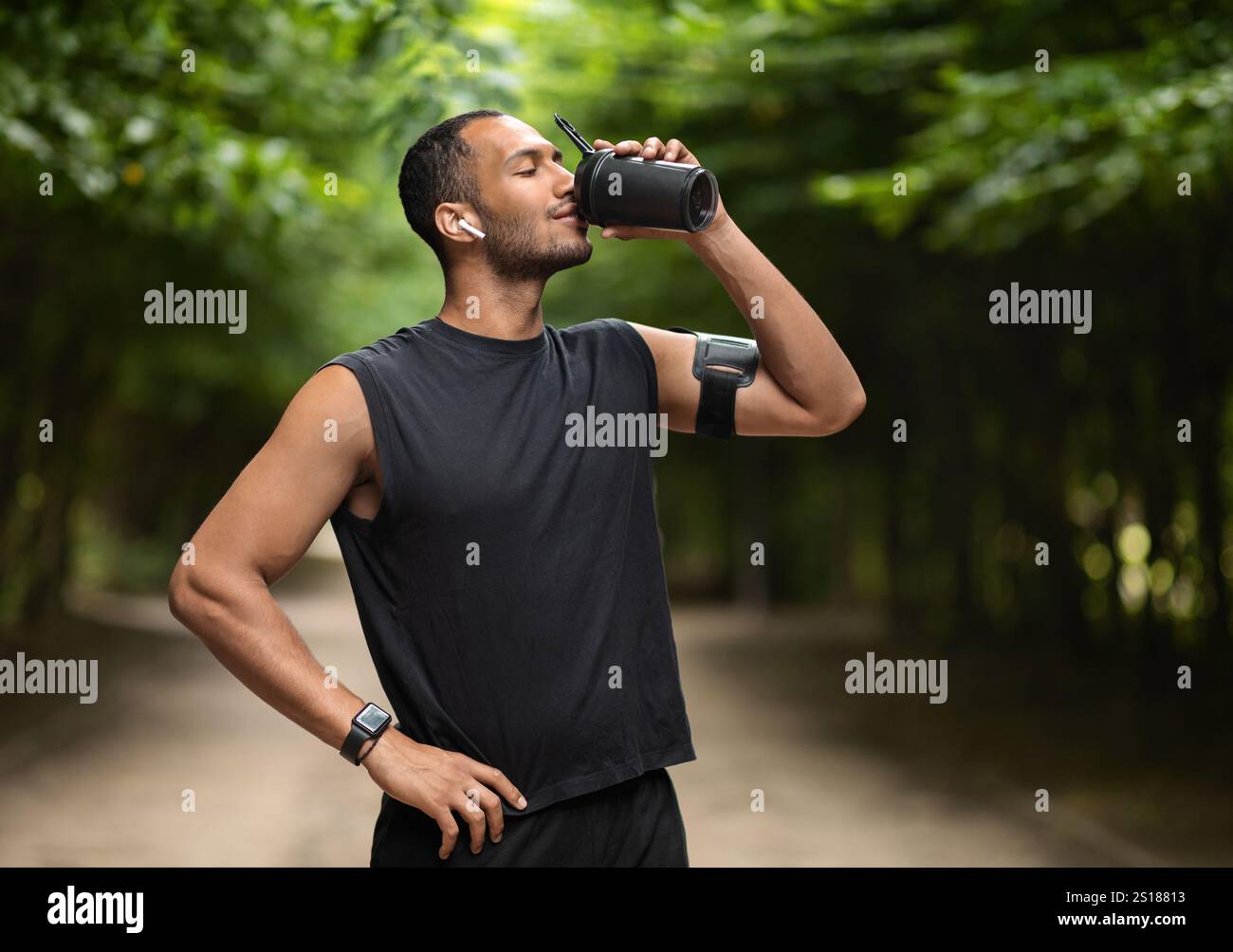Sporty black man drinking protein cocktail, training at park Stock ...