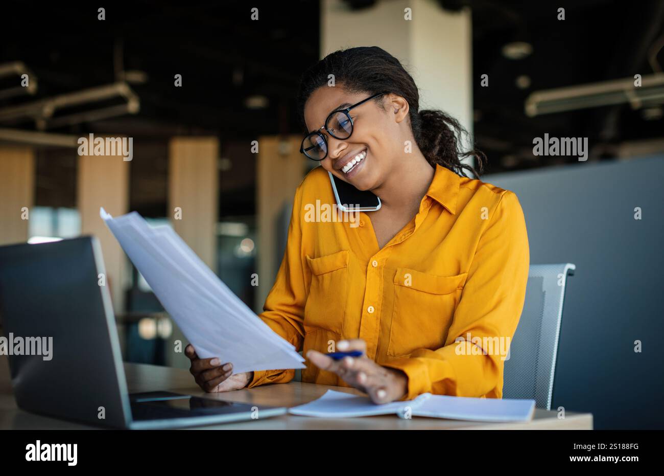 Corporate communication. Happy black female manager working with papers ...