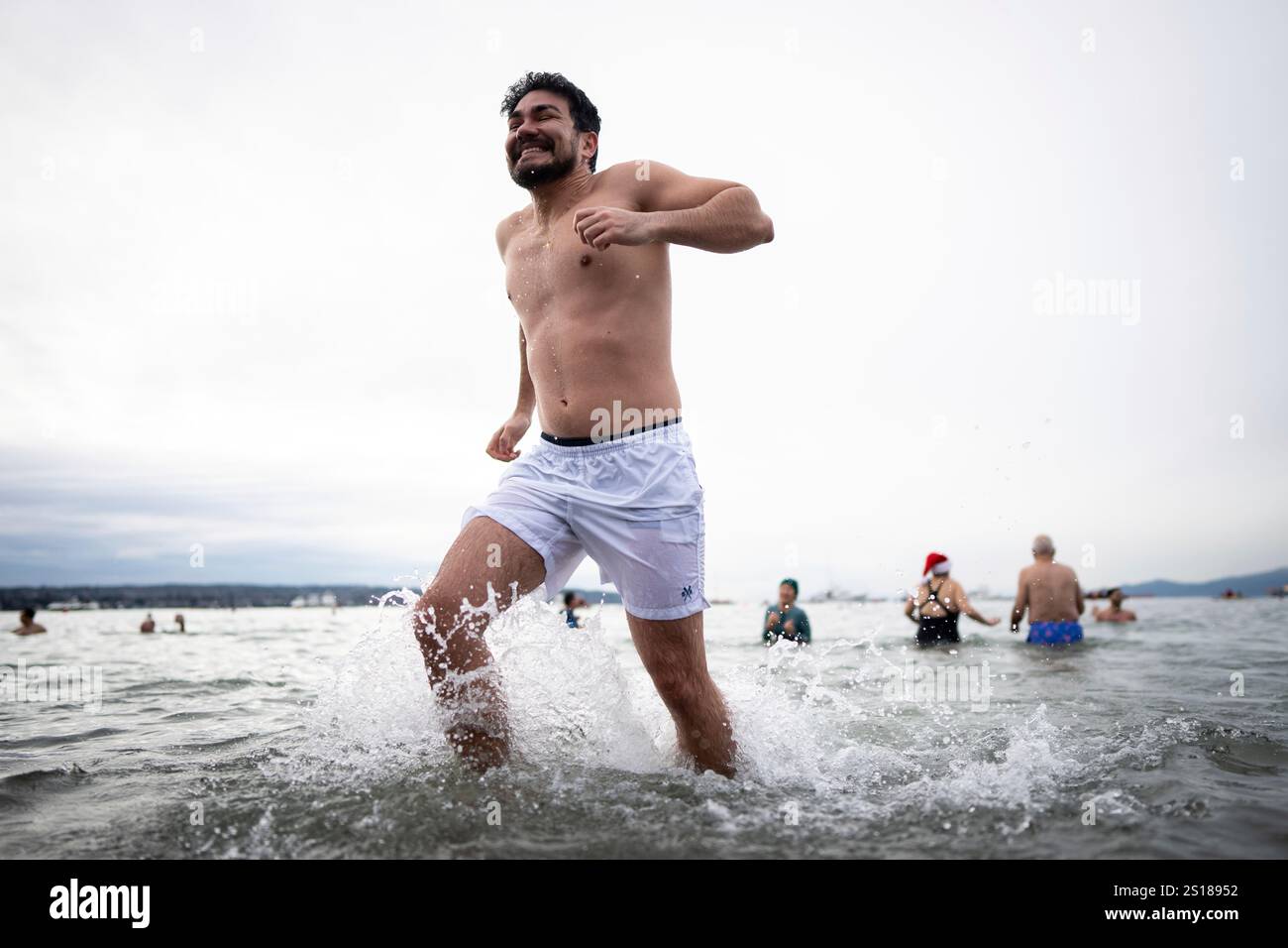 A man exits the water during the Polar Bear Swim on New Year's Day at ...