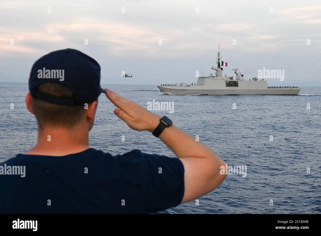 A crew member aboard the Coast Guard Cutter Eagle (WIX 327) renders ...