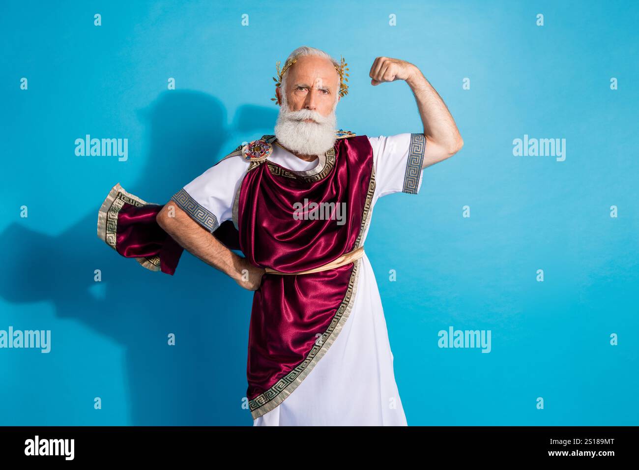 Photo of attractive old man powerful show biceps dressed greek god ...