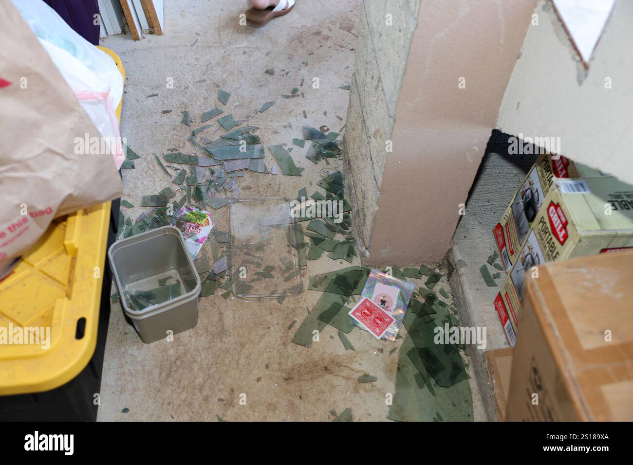 Broken glass from a blown out window is seen at the property of Evelyn ...