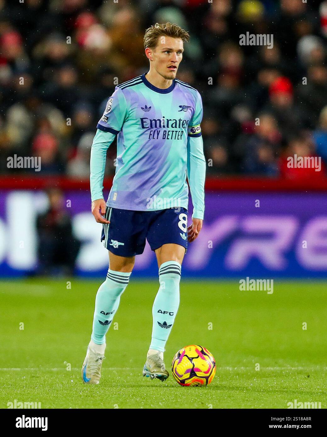 Martin Odegaard of Arsenal runs with the ball during the Premier League ...