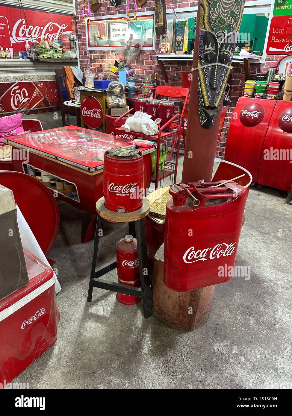 A bright red CocaCola cooler is prominently positioned on top of a ...