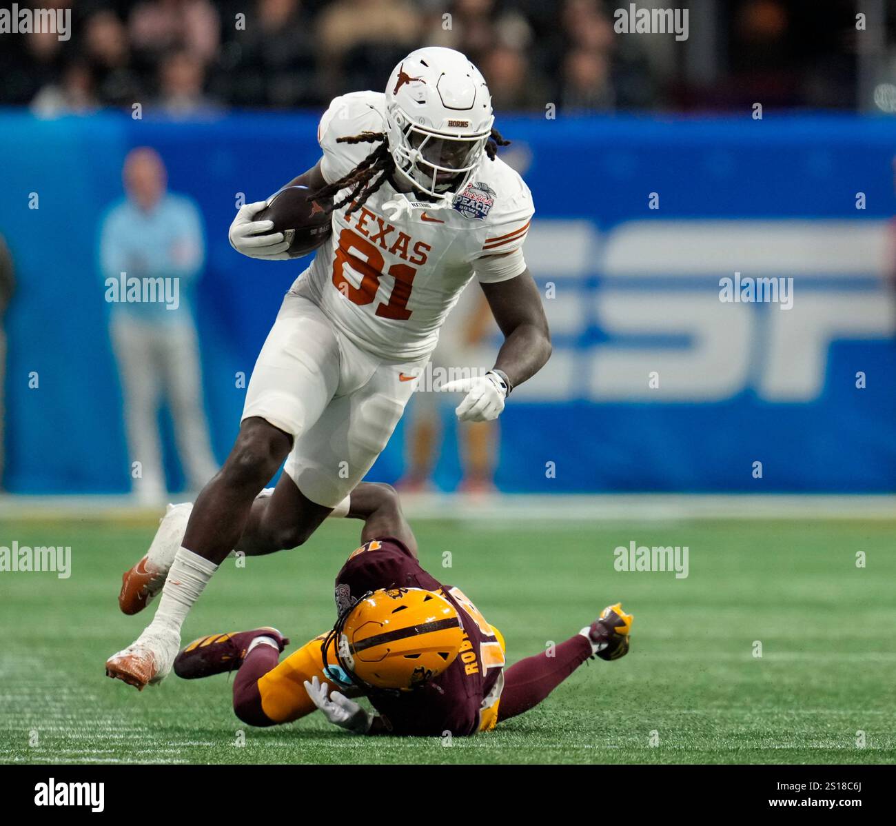 Atlanta, Georgia, USA. 1st Jan, 2025. Texas tight end Juan Davis (81) slips through the tackle ...
