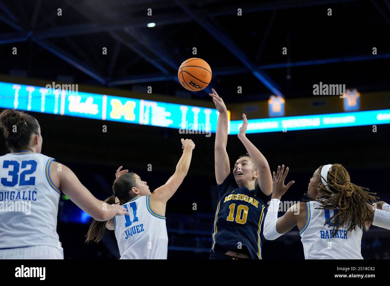 Michigan guard Jordan Hobbs (10) shoots against UCLA forward Angela ...