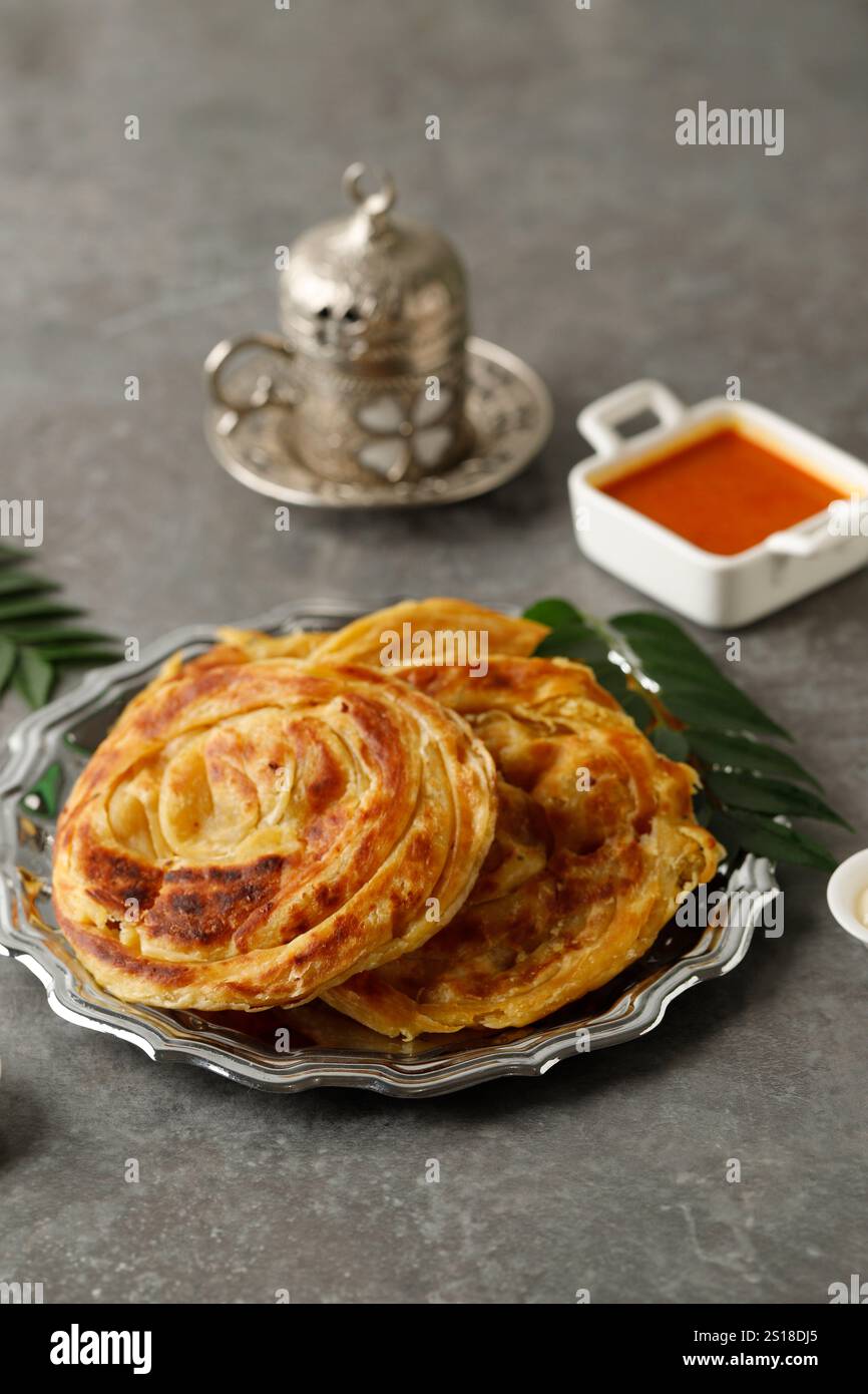 Roti Parata or Roti Canai with Lamb Curry Sauce, Yoghurt and Tea Stock ...