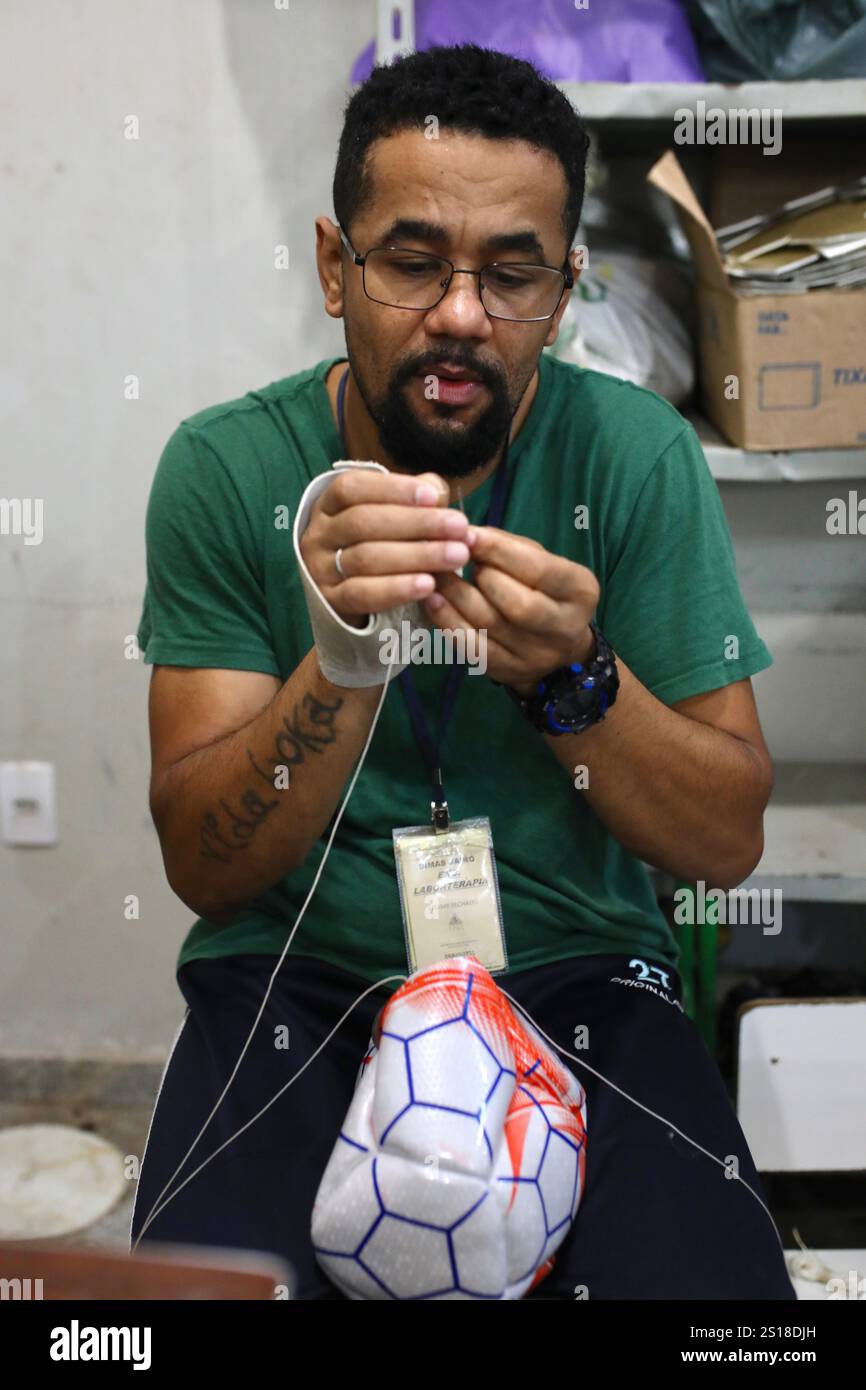 Sao Joao Del Rei, Brazil. 25th Apr, 2023. A prisoner sews a soccer ball ...