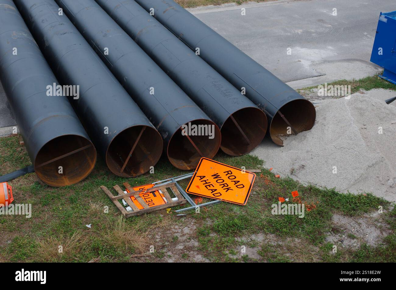Wide view over five black Raw Water Transmission Main Pipes laying on ...