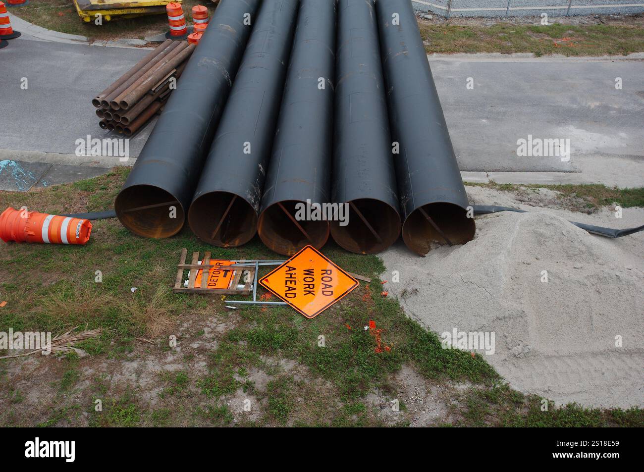 Wide view over five black Raw Water Transmission Main Pipes laying on ...
