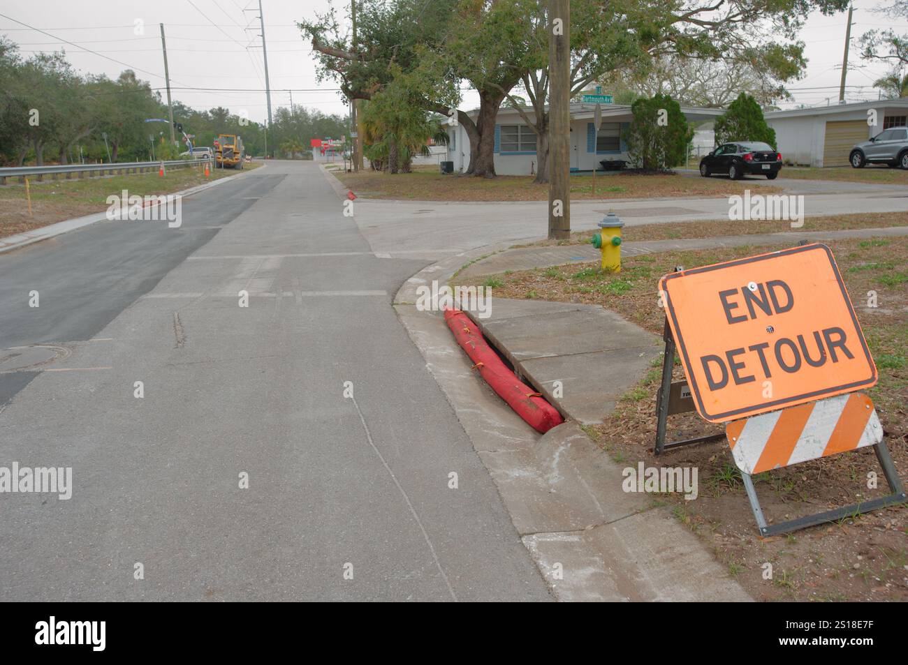 Red Storm Drain Inlet Protection barrier around storm sewer on side of ...